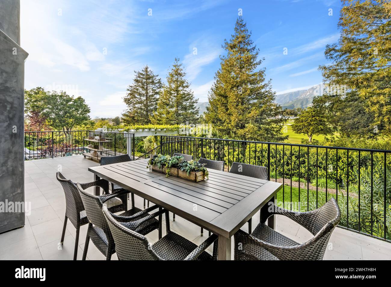 A deck with outdoor dining set overlooking scenic vineyard Stock Photo ...