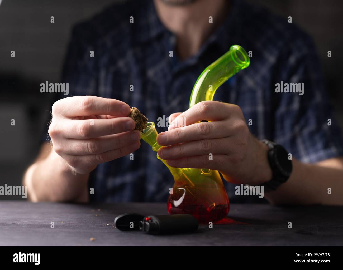 Man Fills Bong With Cannabis Leaves, Hands In Close-Up View Stock Photo ...