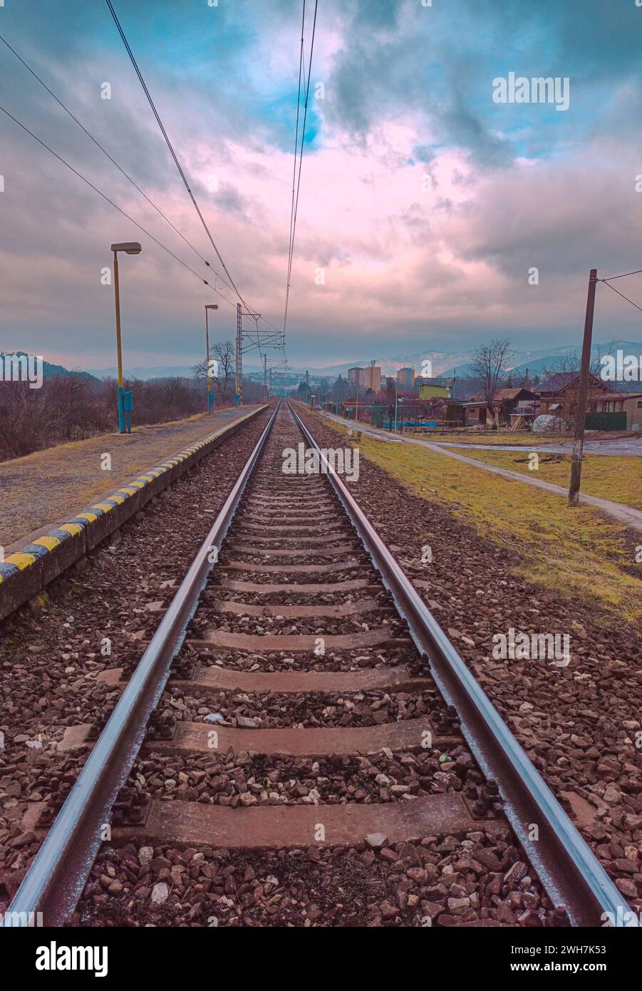 The parallel railroad tracks at a small train station in eastern ...