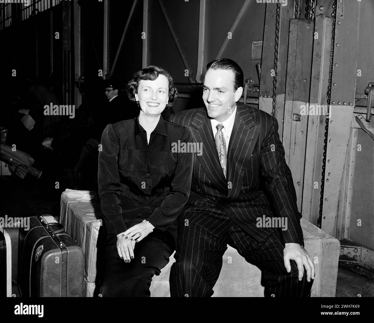 Randolph A. Hearst, right, and his wife Catherine sit on their luggage ...