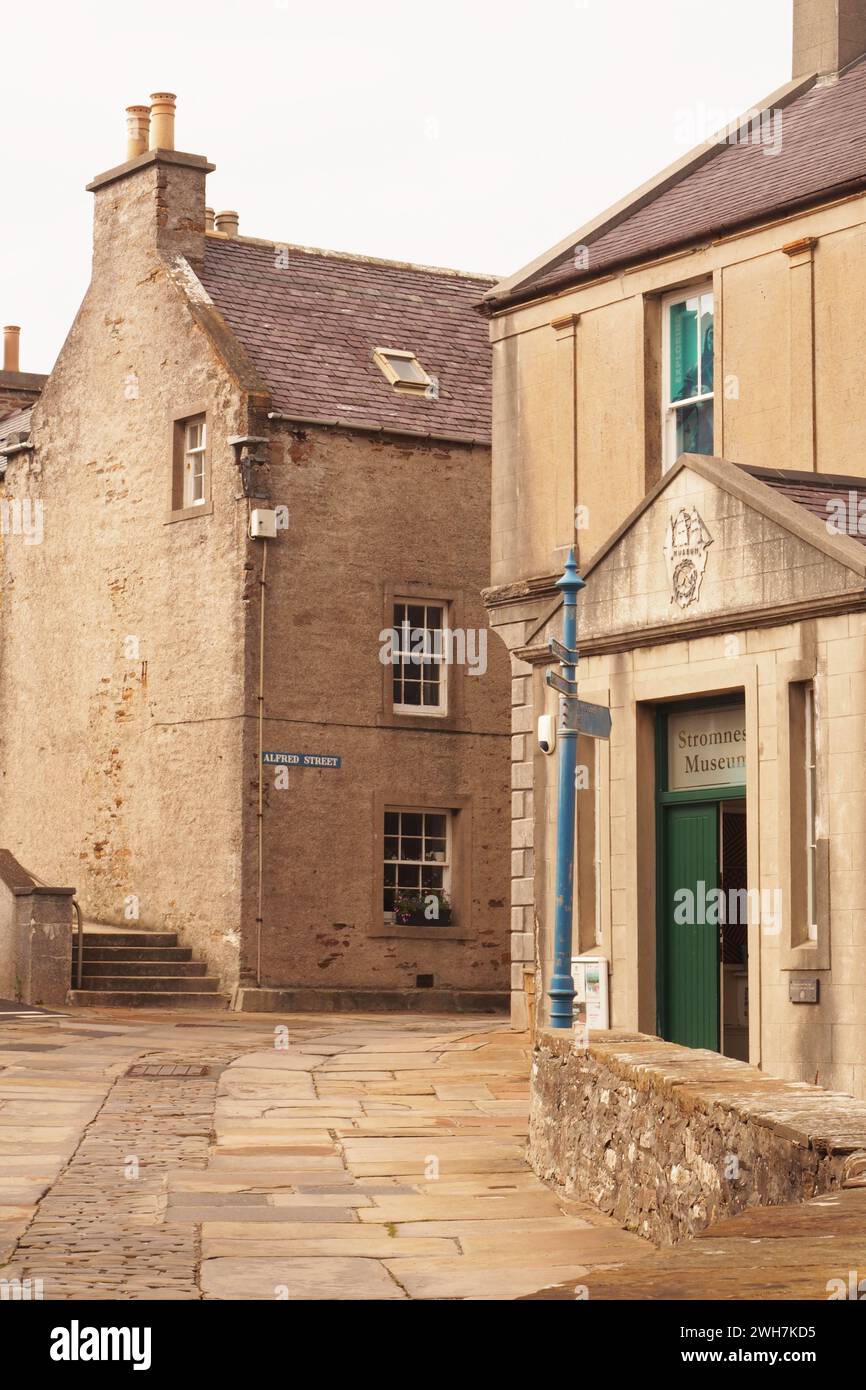 View of narrow, paved street street in Stromness, Orkney UK, showing ...