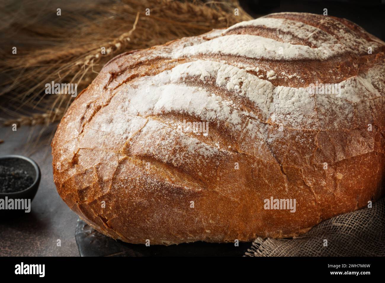 Close-up of a loaf of freshly baked homemade bread on the table. Whole ...