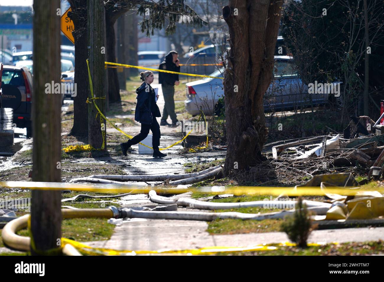 Investigators work at the scene where two police officers were injured ...