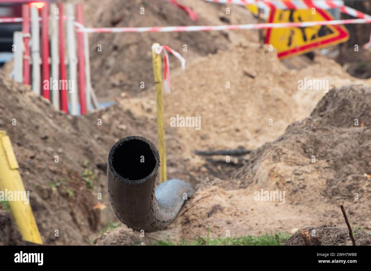 Black plastic pipe for underground water supply. PVC pipe. Sewer system ...