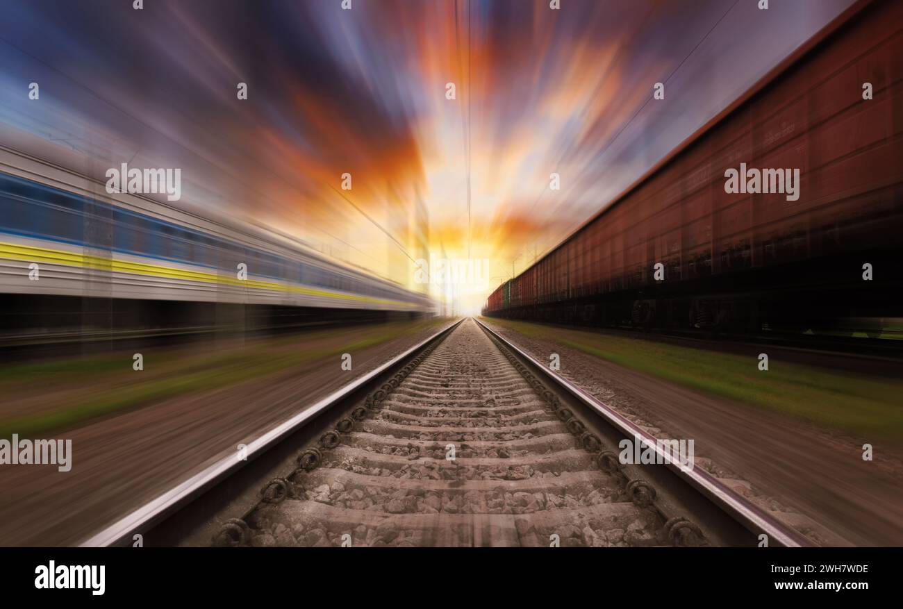 Railroad in motion at sunset with dramatic sky. Motion blur effect ...