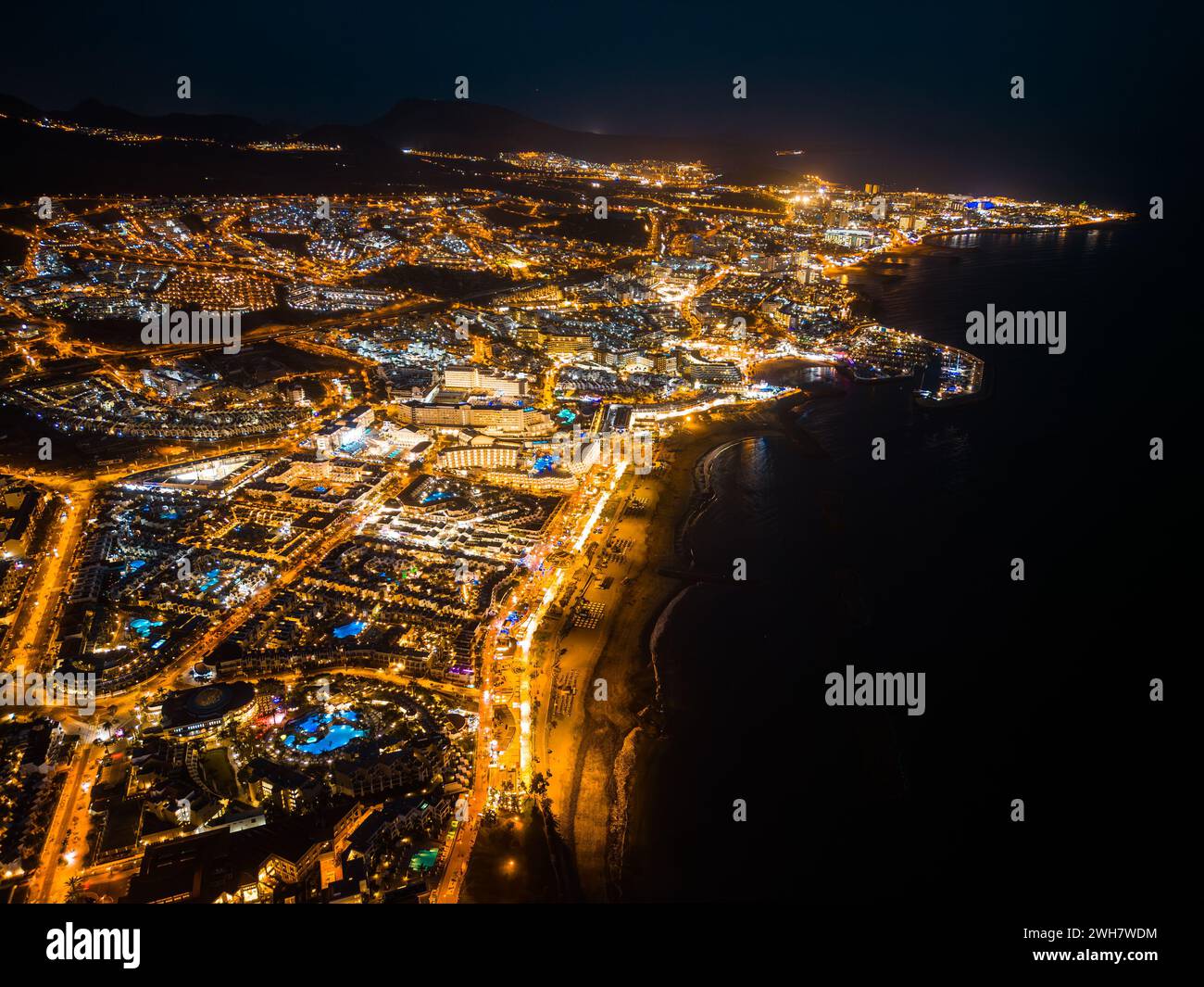 aerial view of illuminated light night city with coast, Tenerife ...