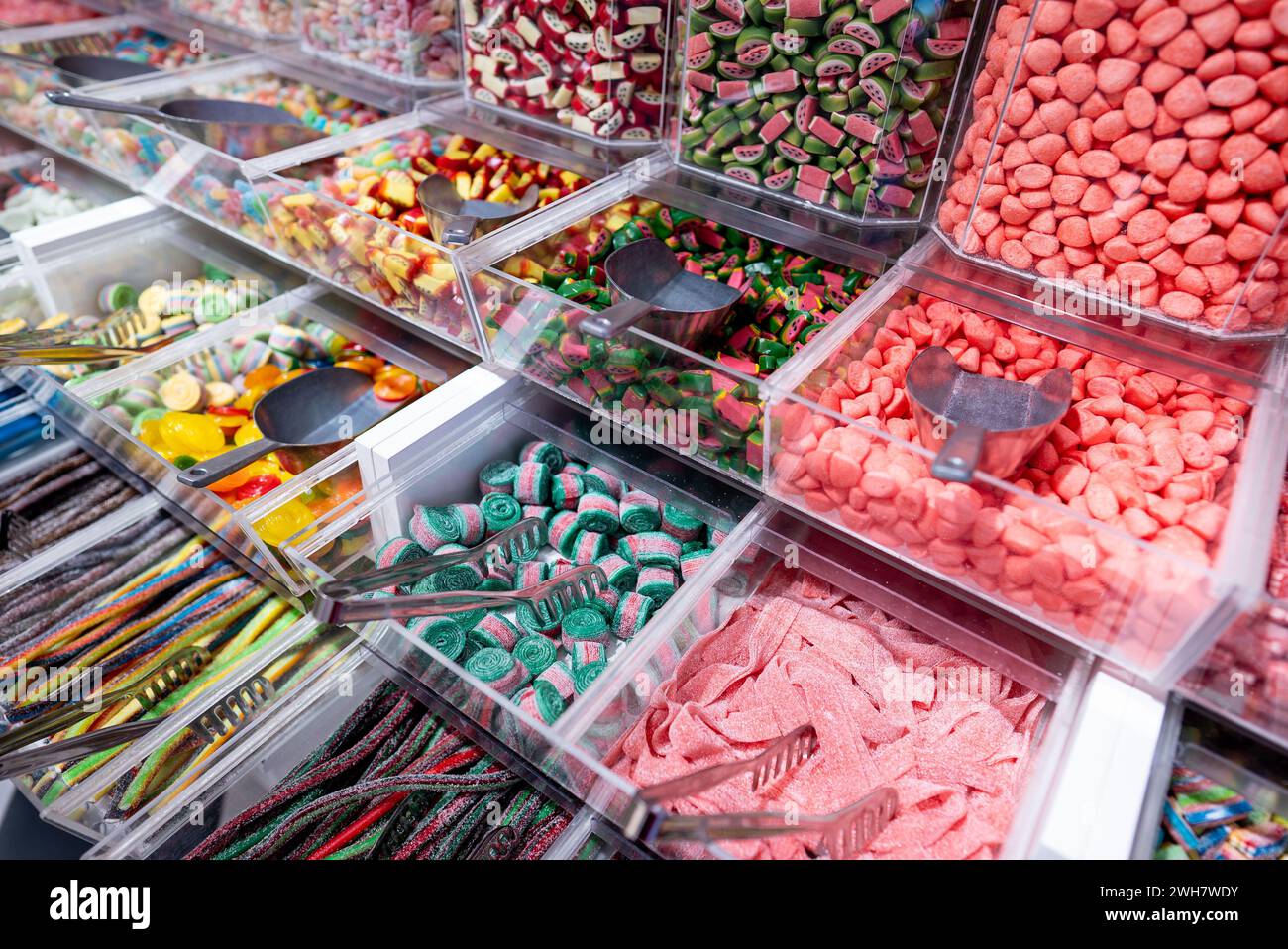 showcase of candy shop, transparent container with various sweets ...