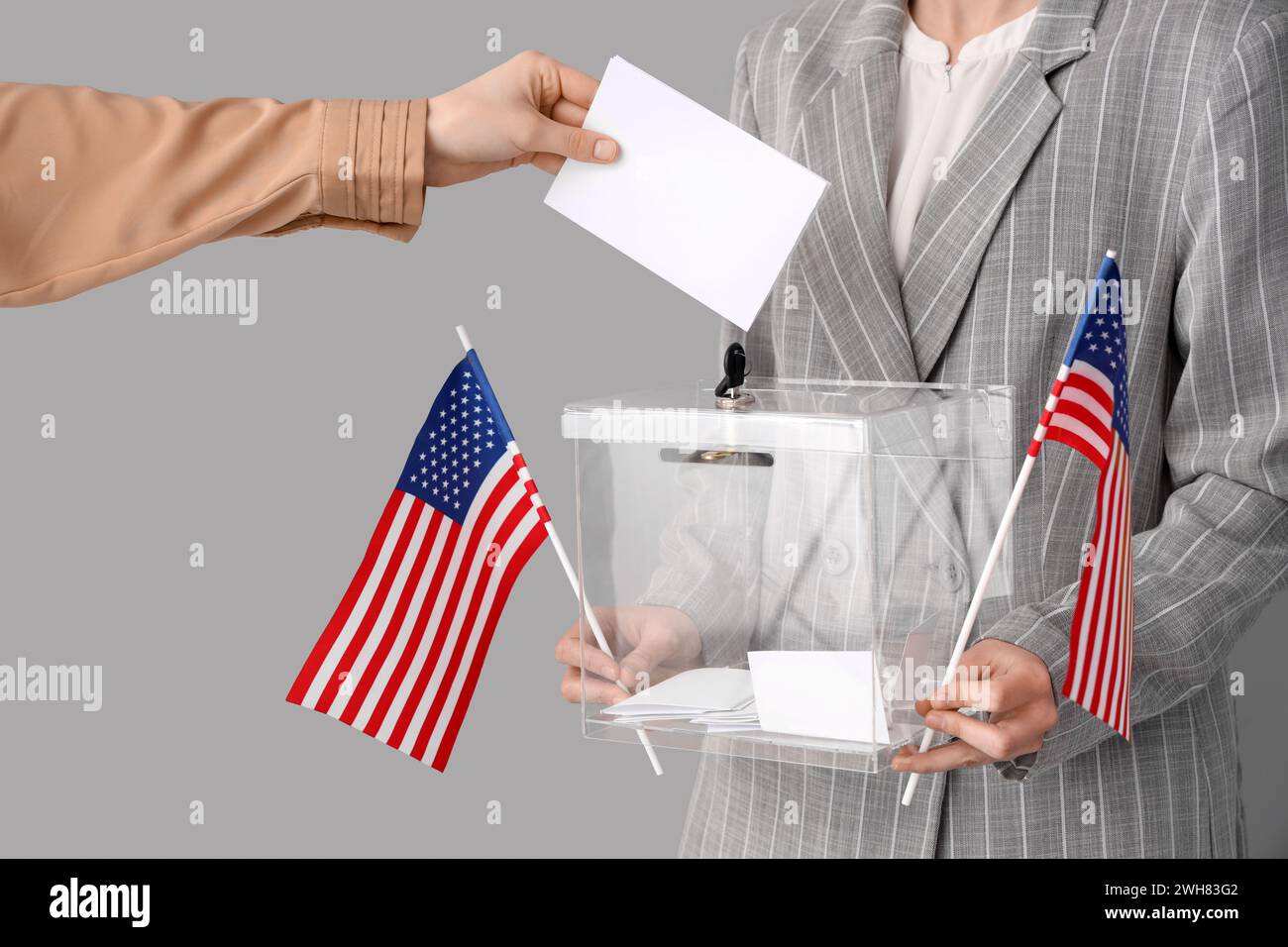 Hand putting voting paper into ballot box on white background. Election ...