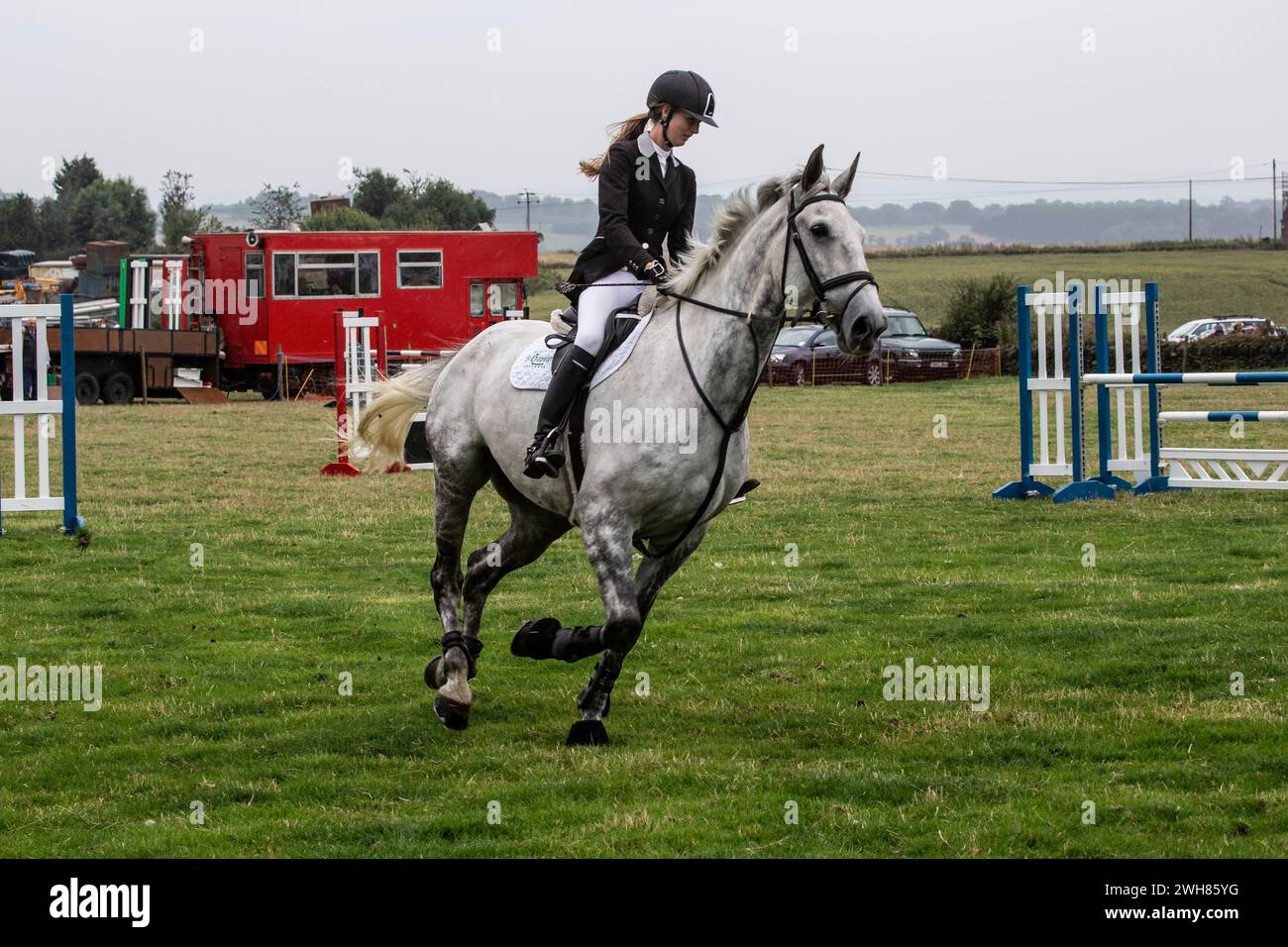 Female competitor on a horse in a regional equestrian show jumping ...