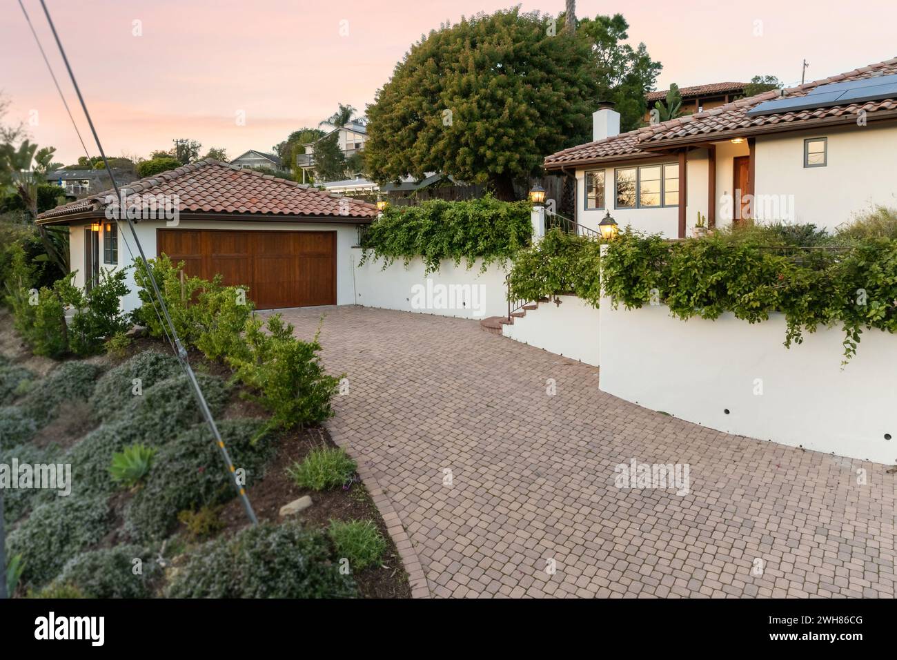 Red brick driveway with two garages Stock Photo - Alamy