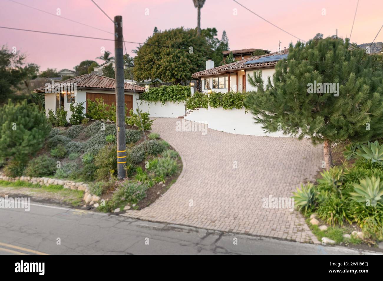 Residential house at the corner of a street with a driveway Stock Photo ...