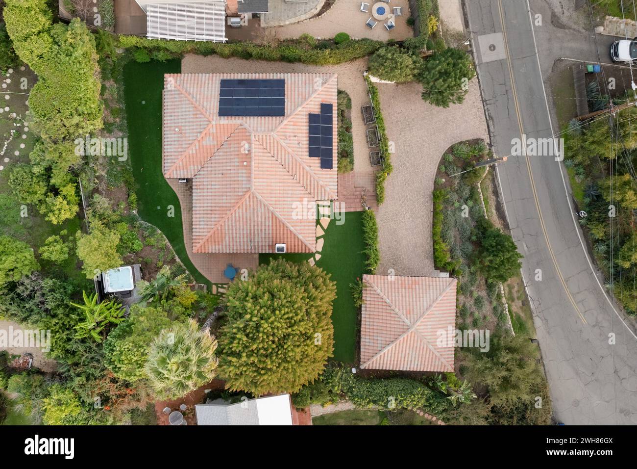 Aerial view of solar-powered residential home with panels on the roof ...