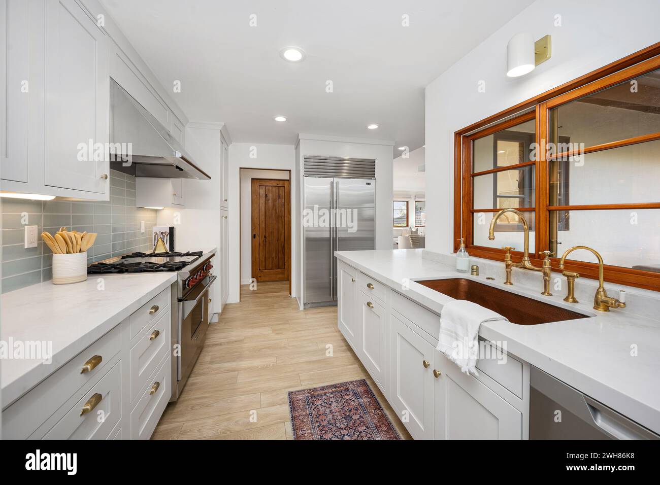 Kitchen with sink and large window in center Stock Photo - Alamy