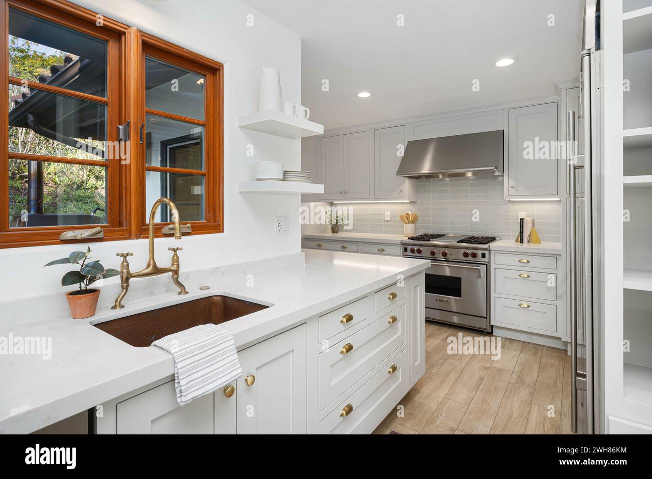Kitchen with wooden window above white countertop Stock Photo - Alamy