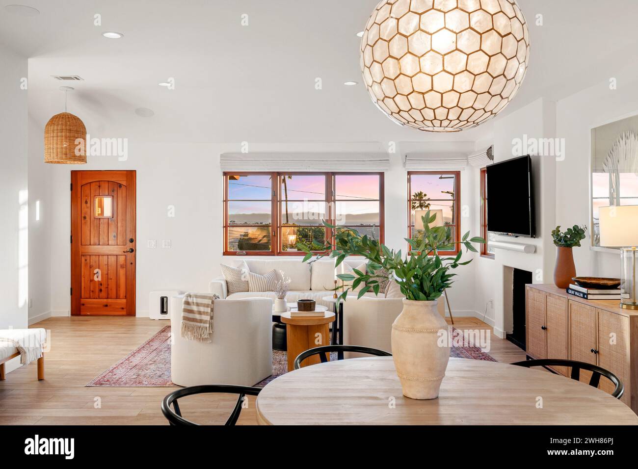 A cozy living room with comfortable seating and a large TV Stock Photo ...
