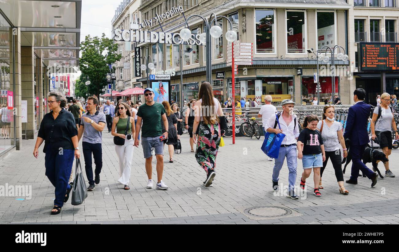 Colorful street scene of a diverse group of shoppers, tourists and ...