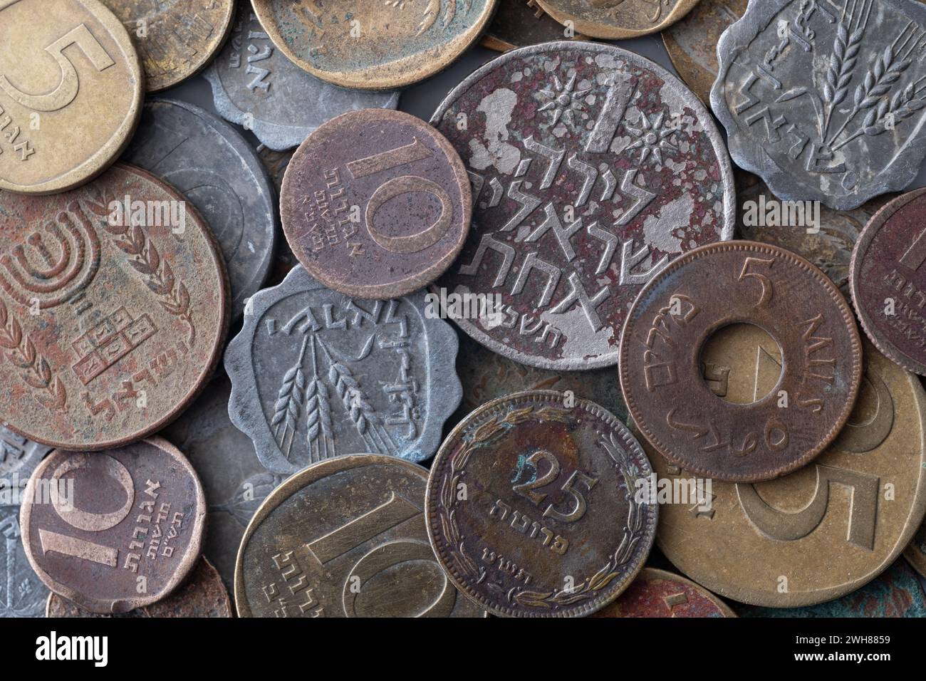 heap of old Israeli coins, including 25 agorot, reflects the historical ...