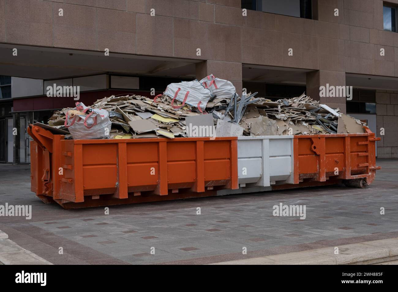 huge heap on metal Big Overloaded dumpster waste container filled with ...