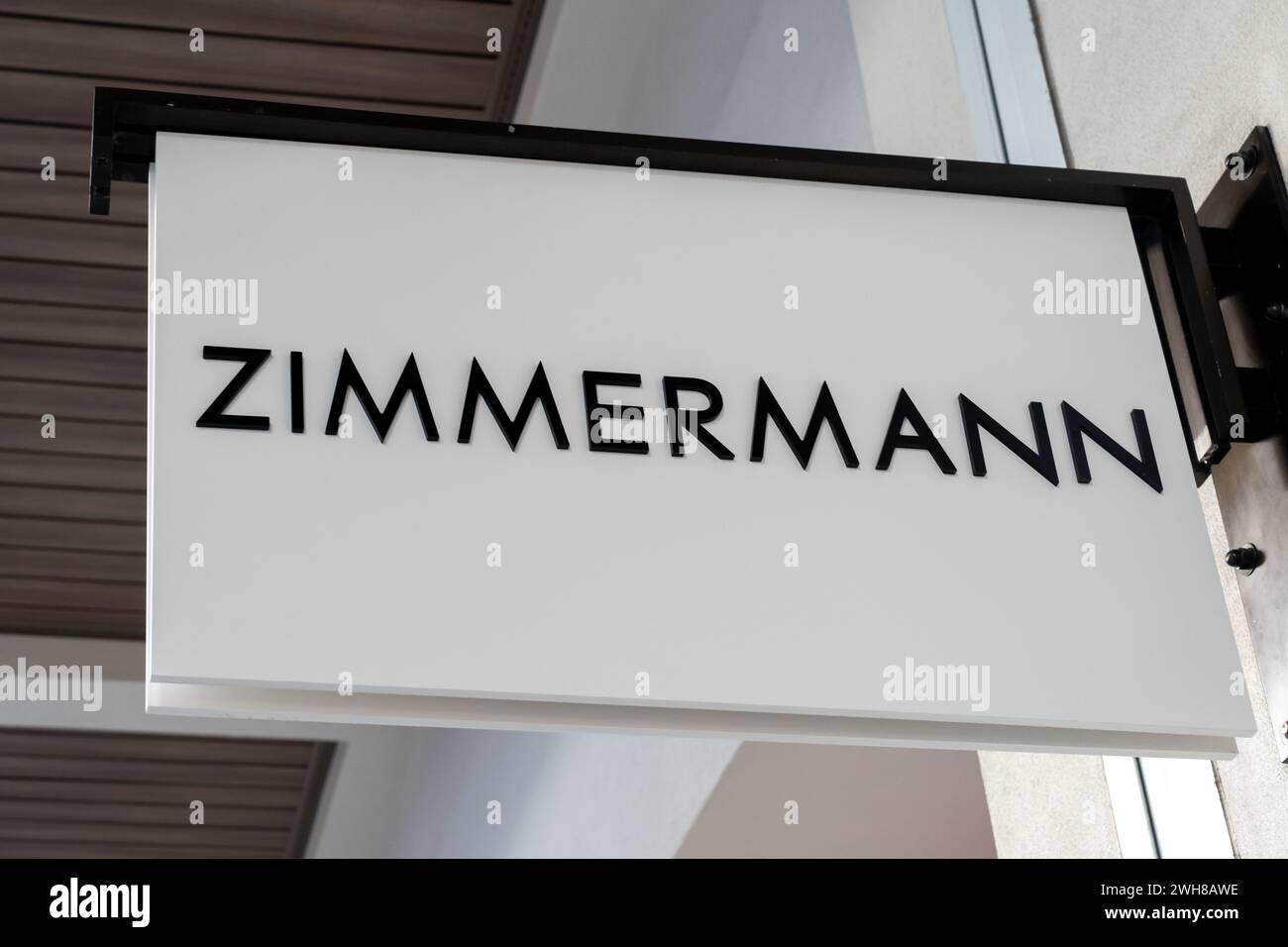 Close-up of Zimmermann hanging logo sign at their store in a shopping ...