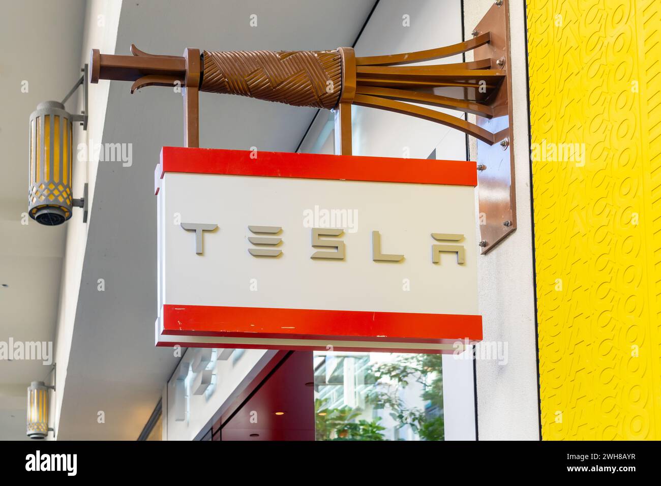 Close-up of Tesla hanging logo sign at their showroom in a shopping ...
