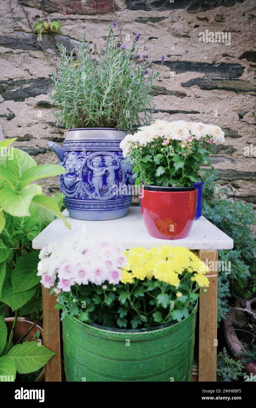 Pretty patio vignette with table, potted plants, cobalt blue pottery ...