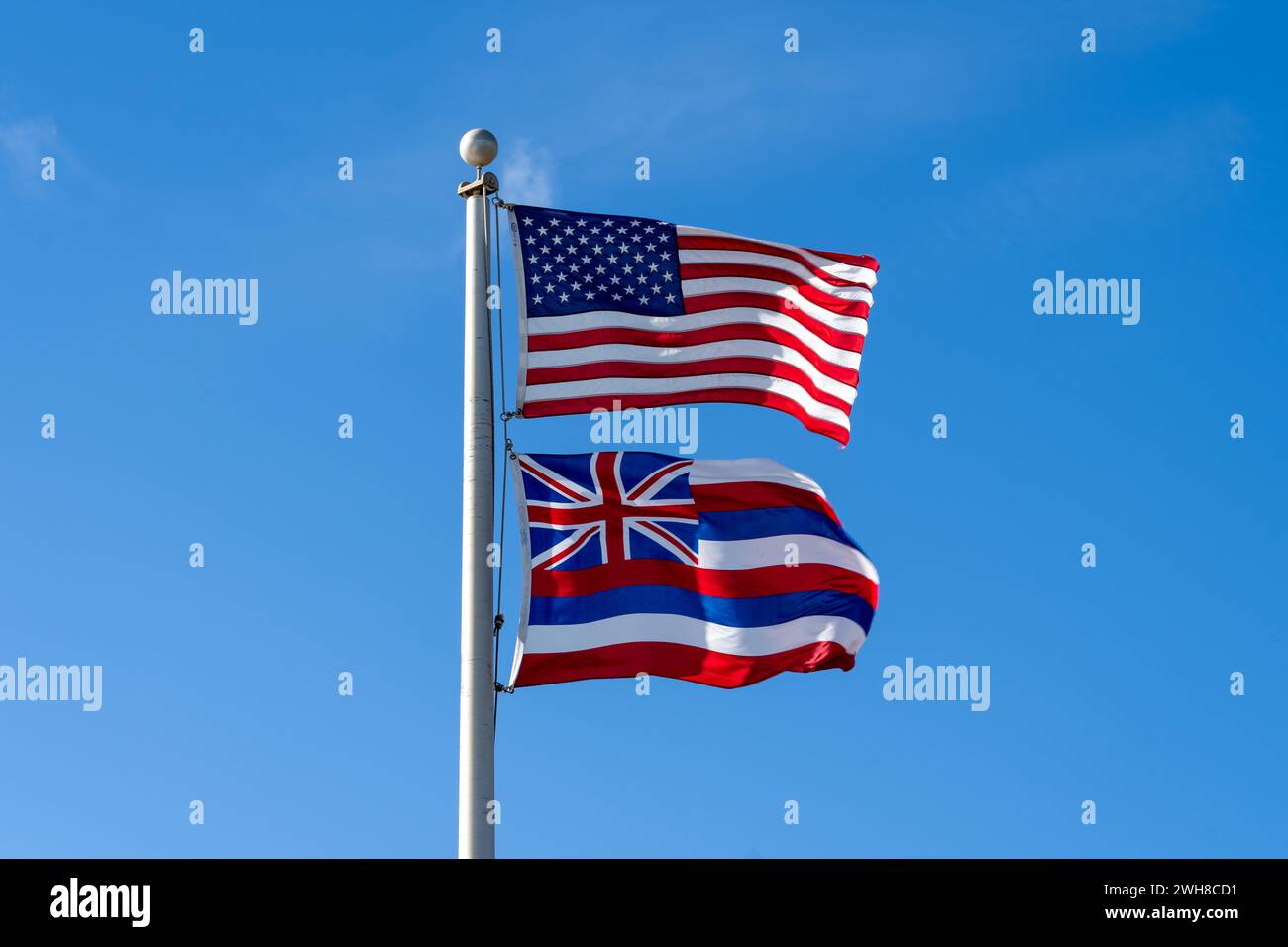 Flag of the United States and flag of Hawaii with blue sky background ...