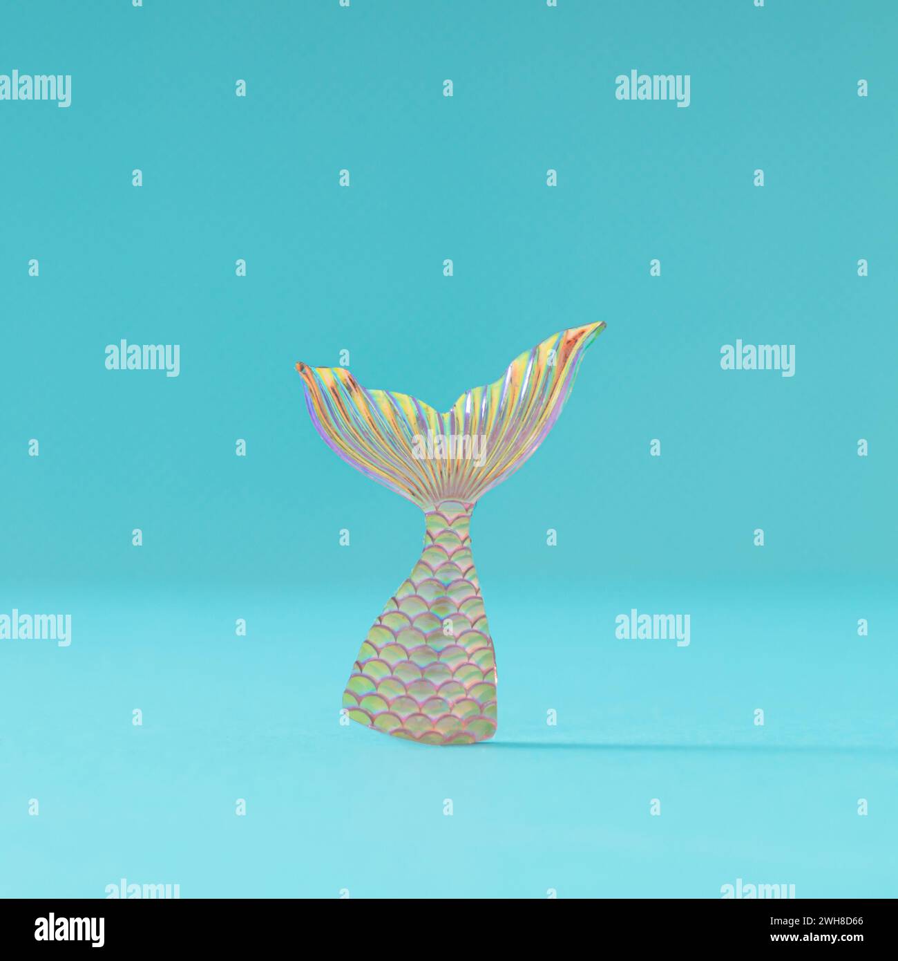 Summer layout made with mermaid's tail on light bright blue background ...