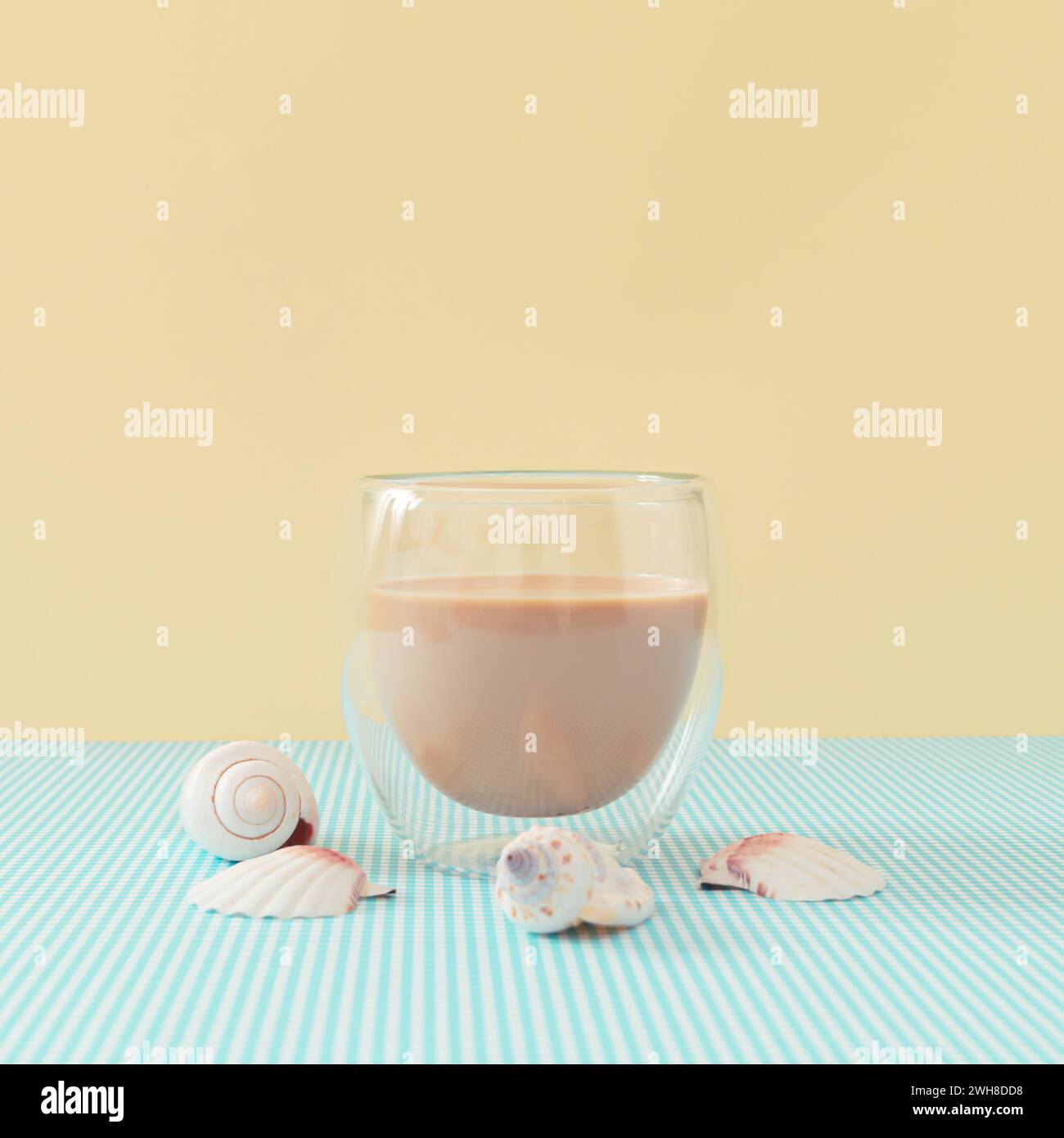 Creative summer layout made with cup of coffee and sea shells on light ...