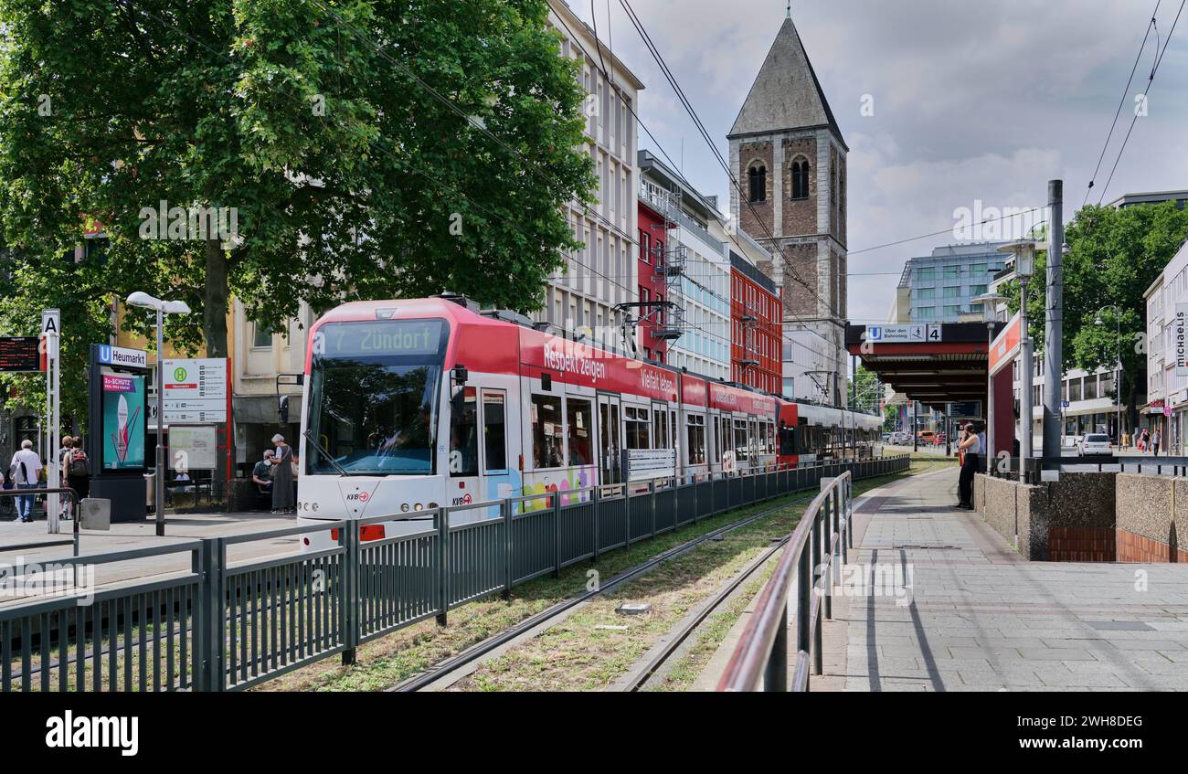Urban street scene of electric tram at the platform in downtown Cologne ...