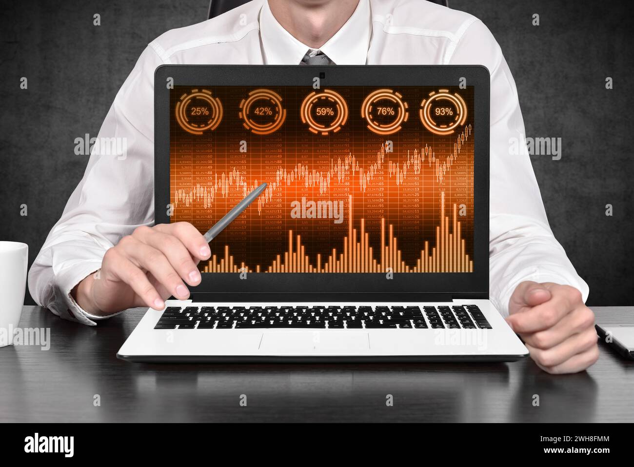 Businessman pointing on laptop screen with percentage charts and ...
