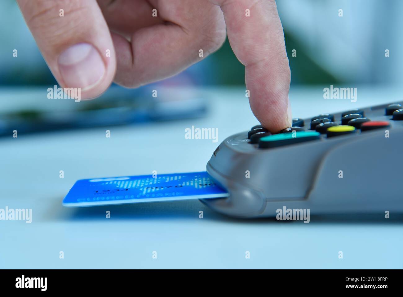 Finger dials pin code on payment terminal. Transaction pay and shopping ...