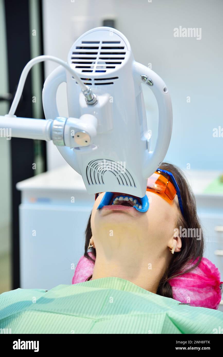 Teeth whitening for patient. Laser bleaching teeth in dental clinic ...