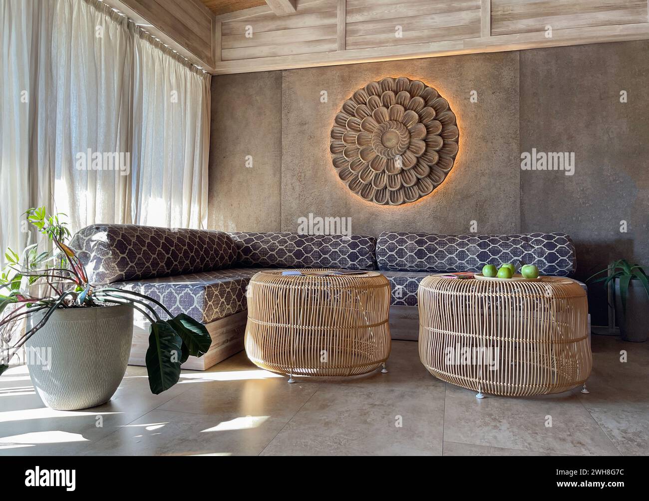 Living room with rattan tables in bali style Stock Photo - Alamy