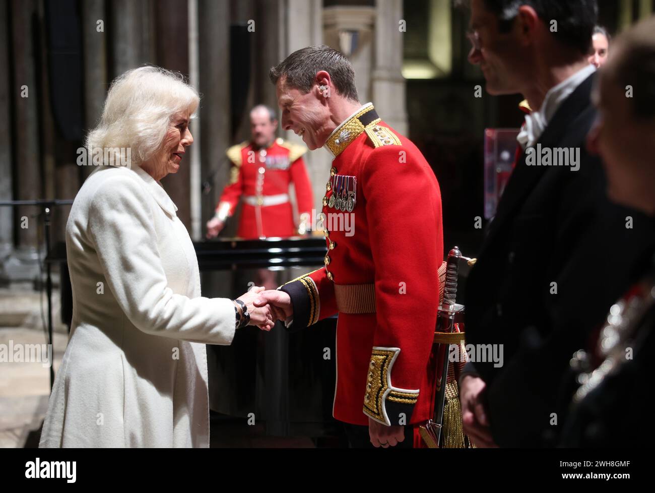 Queen Camilla shakes hands with Captain Robert Smith Director of Music ...