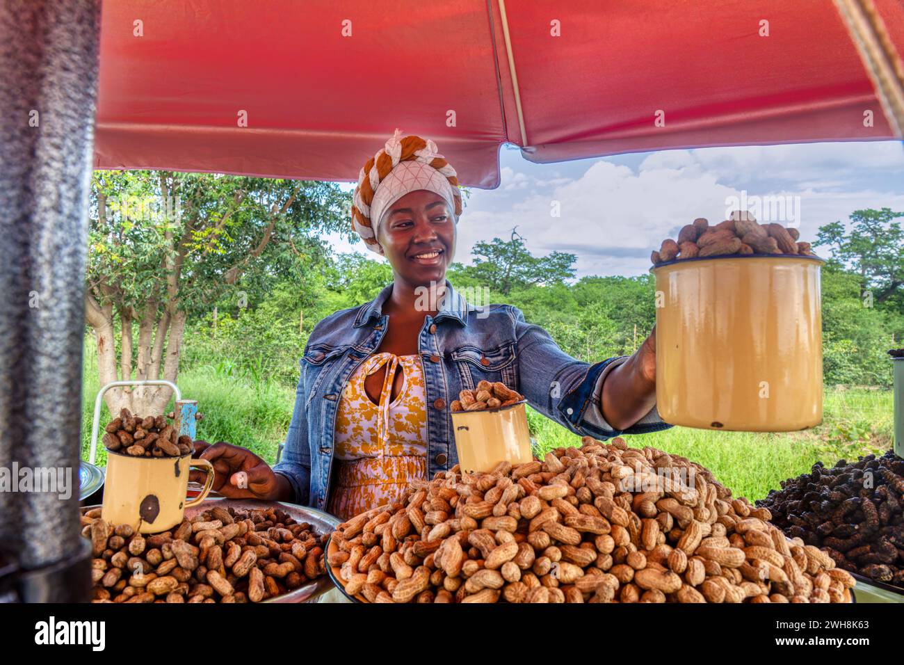 street vendor african woman selling peanuts and mopane worms Stock ...