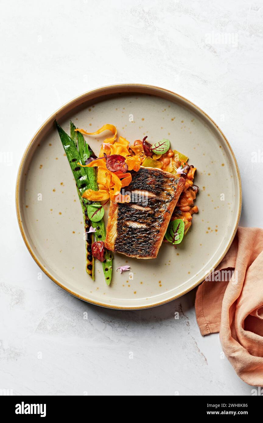 Pan seared barramundi fish fillet, charred leek & bean ragout, sweet ...