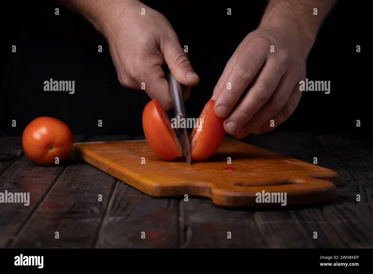 Male hand cutting tomato on hi-res stock photography and images - Alamy