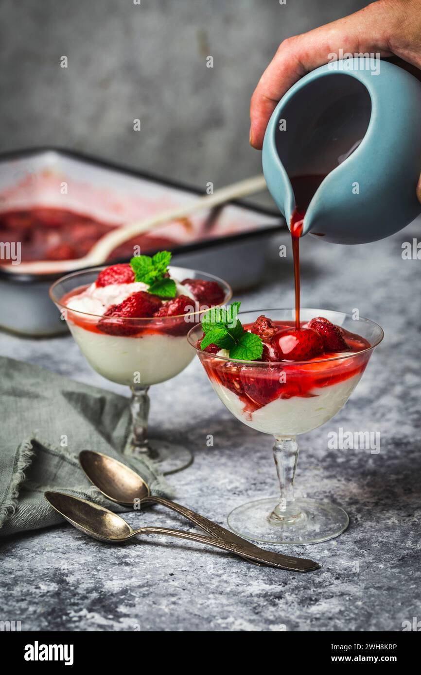 Yogurt and roasted Strawberry Parfaits in vintage glassware with syrup ...