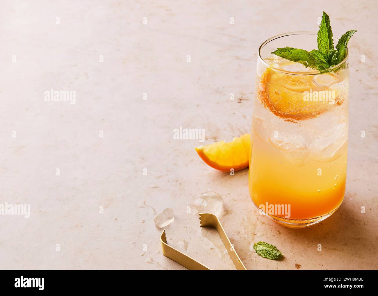 Orange sparkling cocktail with mint garnish Stock Photo - Alamy
