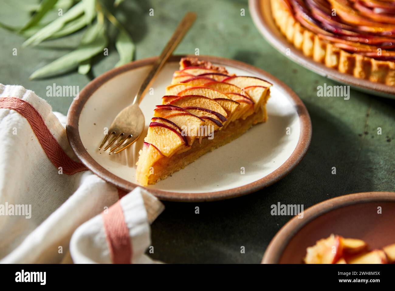 French Apple Tart with layered apples on a green background Stock Photo ...