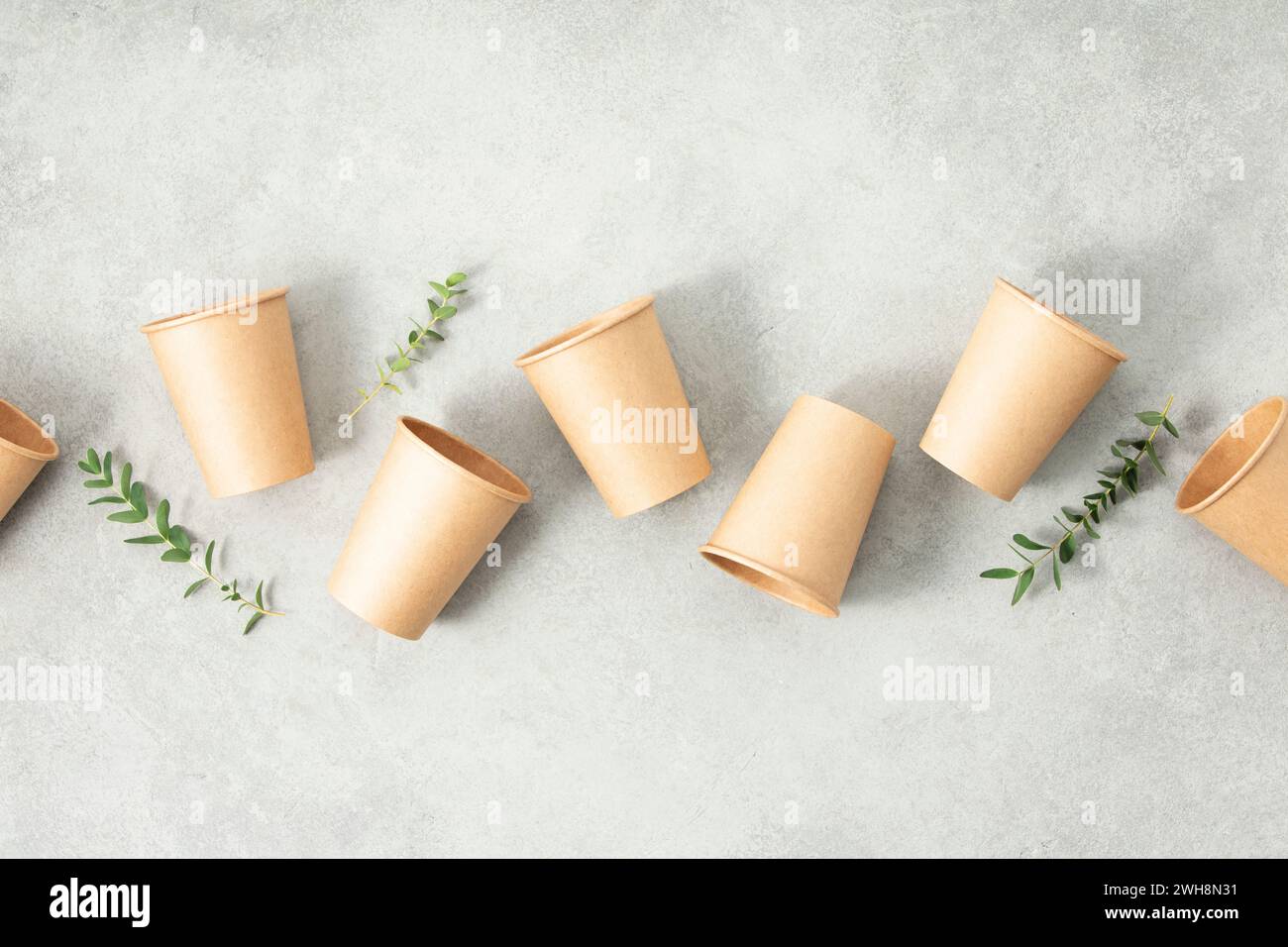 Flat lay composition with eco-friendly paper cups on grey stone ...
