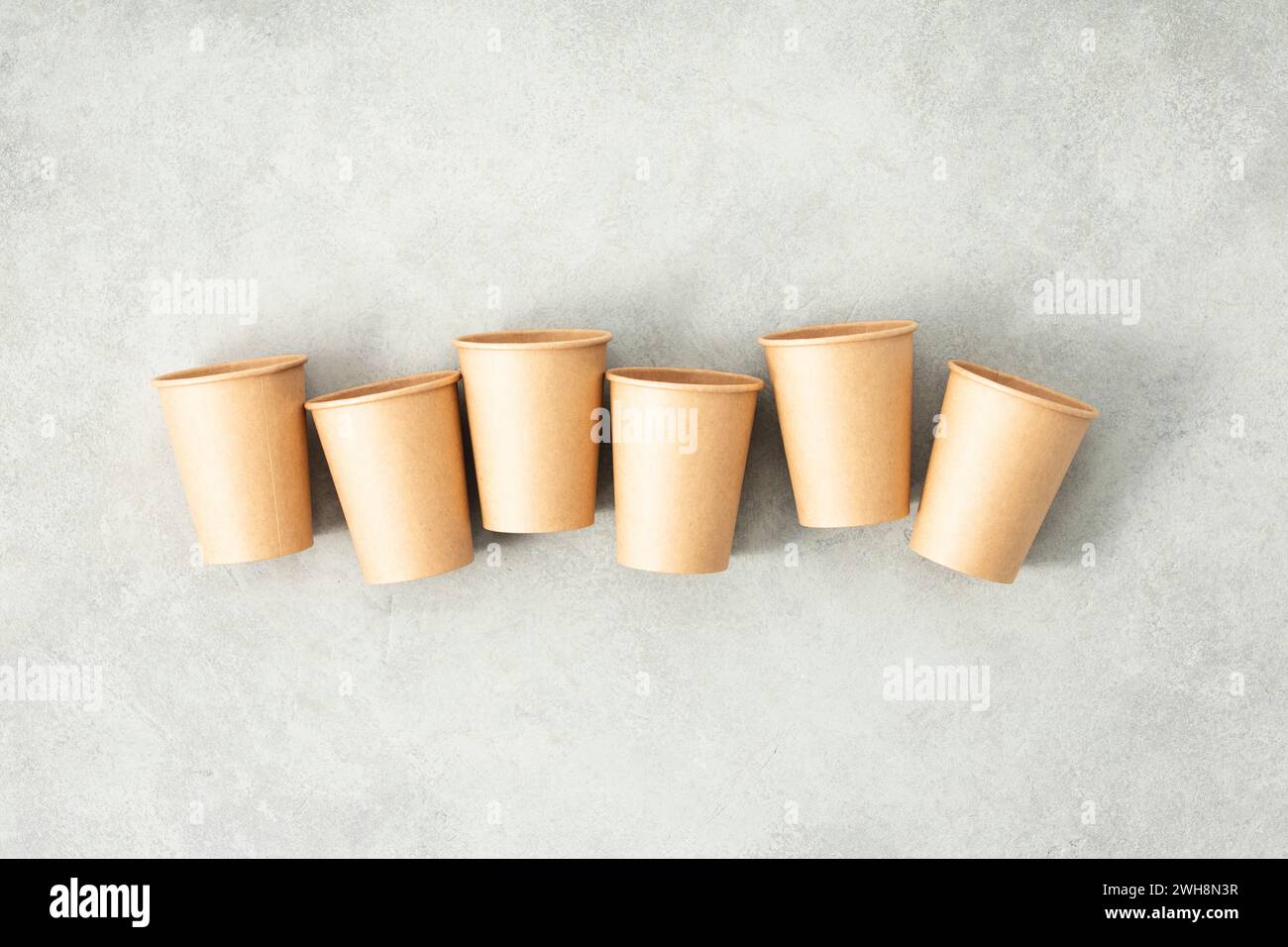 Flat lay composition with eco-friendly paper cups on grey stone ...