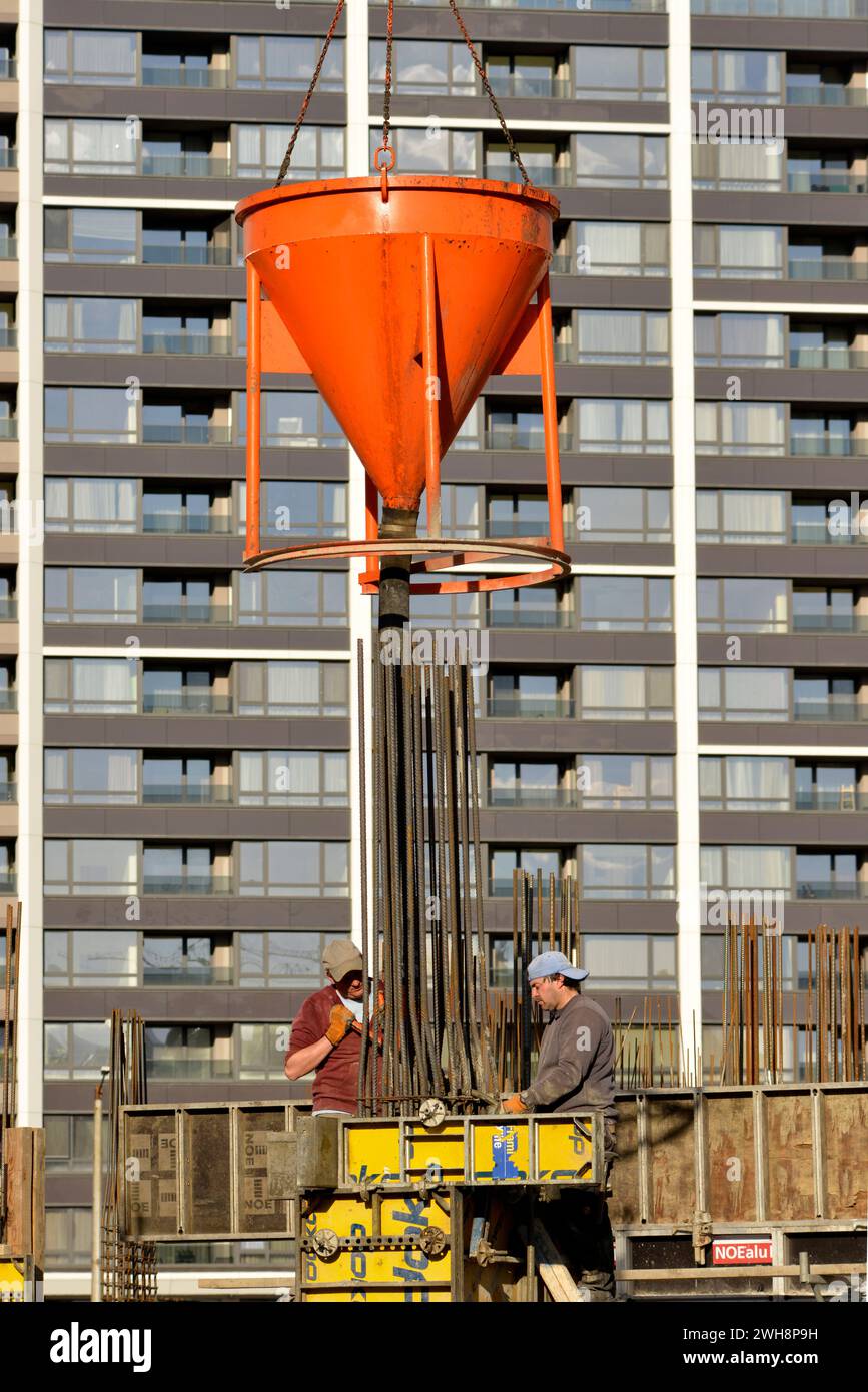 Construction building workers pouring concrete mix in reinforcement ...
