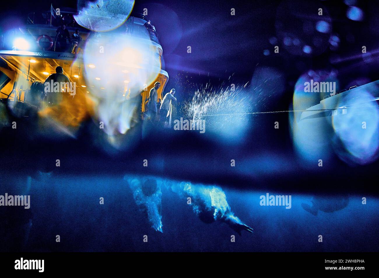 The beauty of the underwater world - diver jumping from boat into water ...