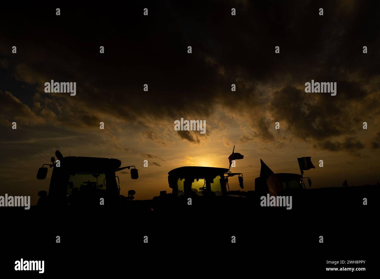 Tractors at sunset parked on a hill where the protest is organized near ...