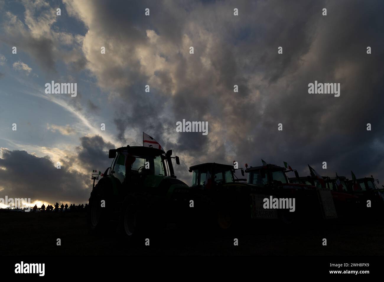 Tractors at sunset parked on a hill where the protest is organized near ...
