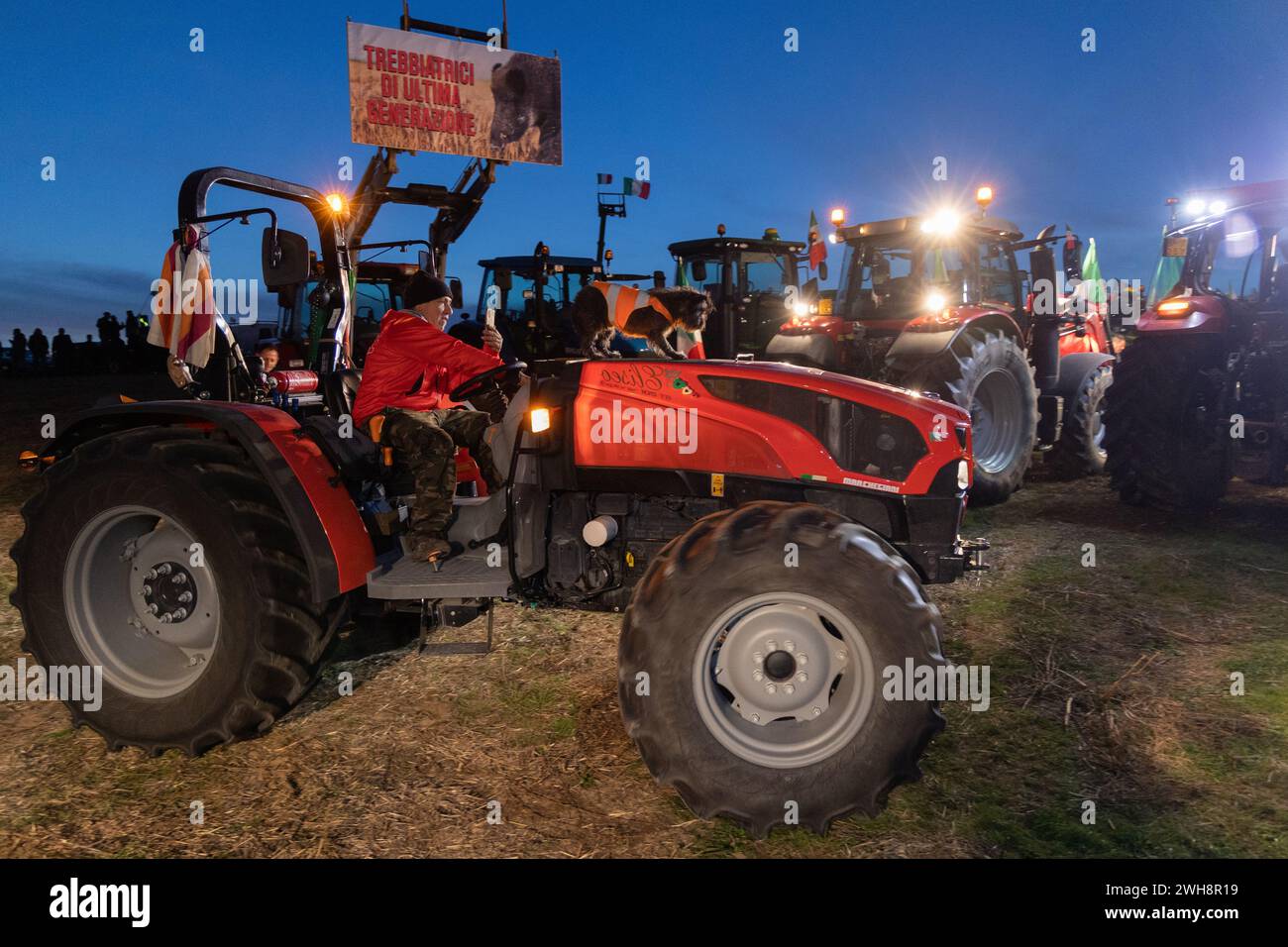 A farmer with his dog on the tractor arrives at the garrison near Via ...