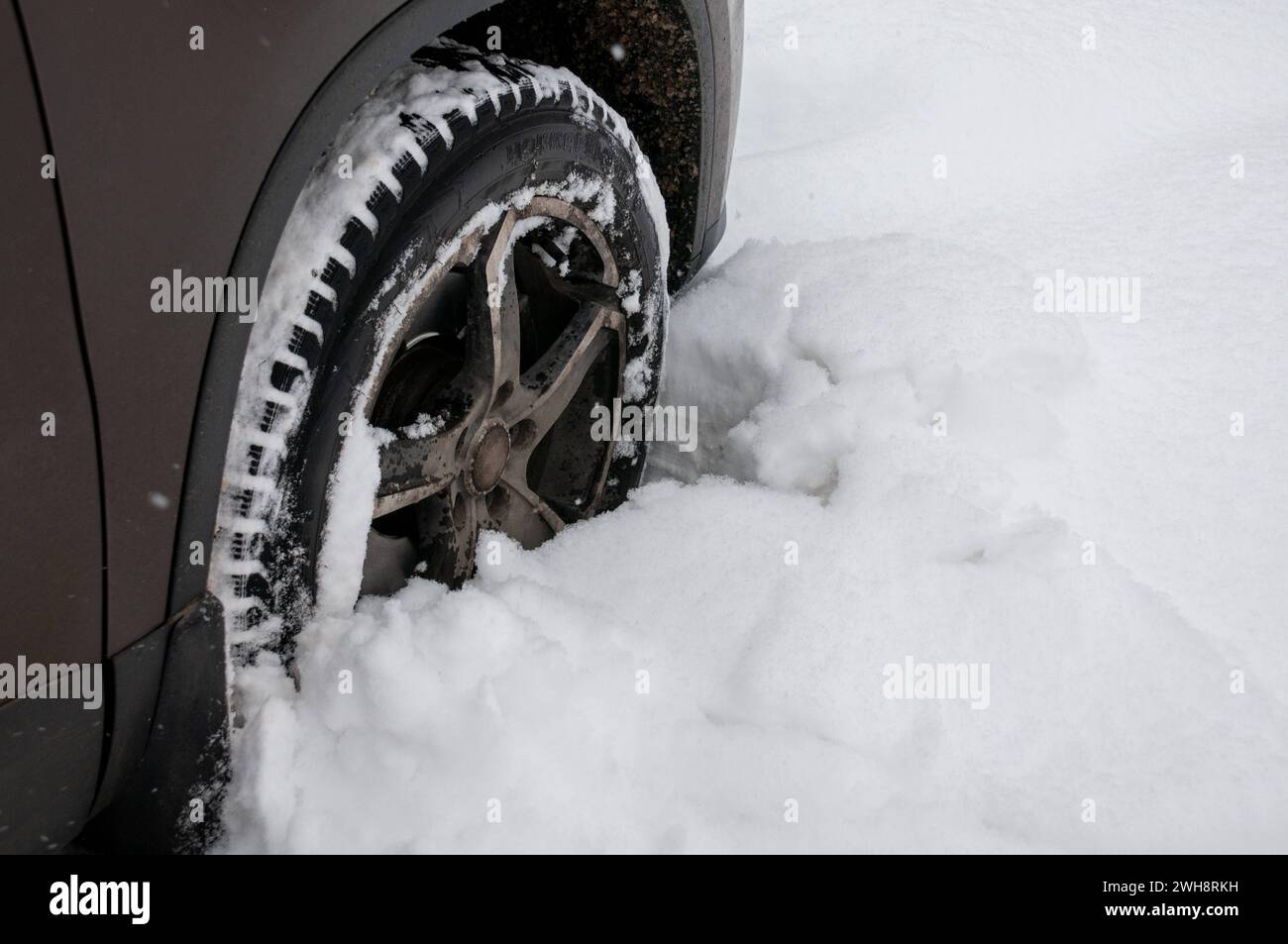 Consequences of snowfall A stuck car in the snow after a snowfall ...