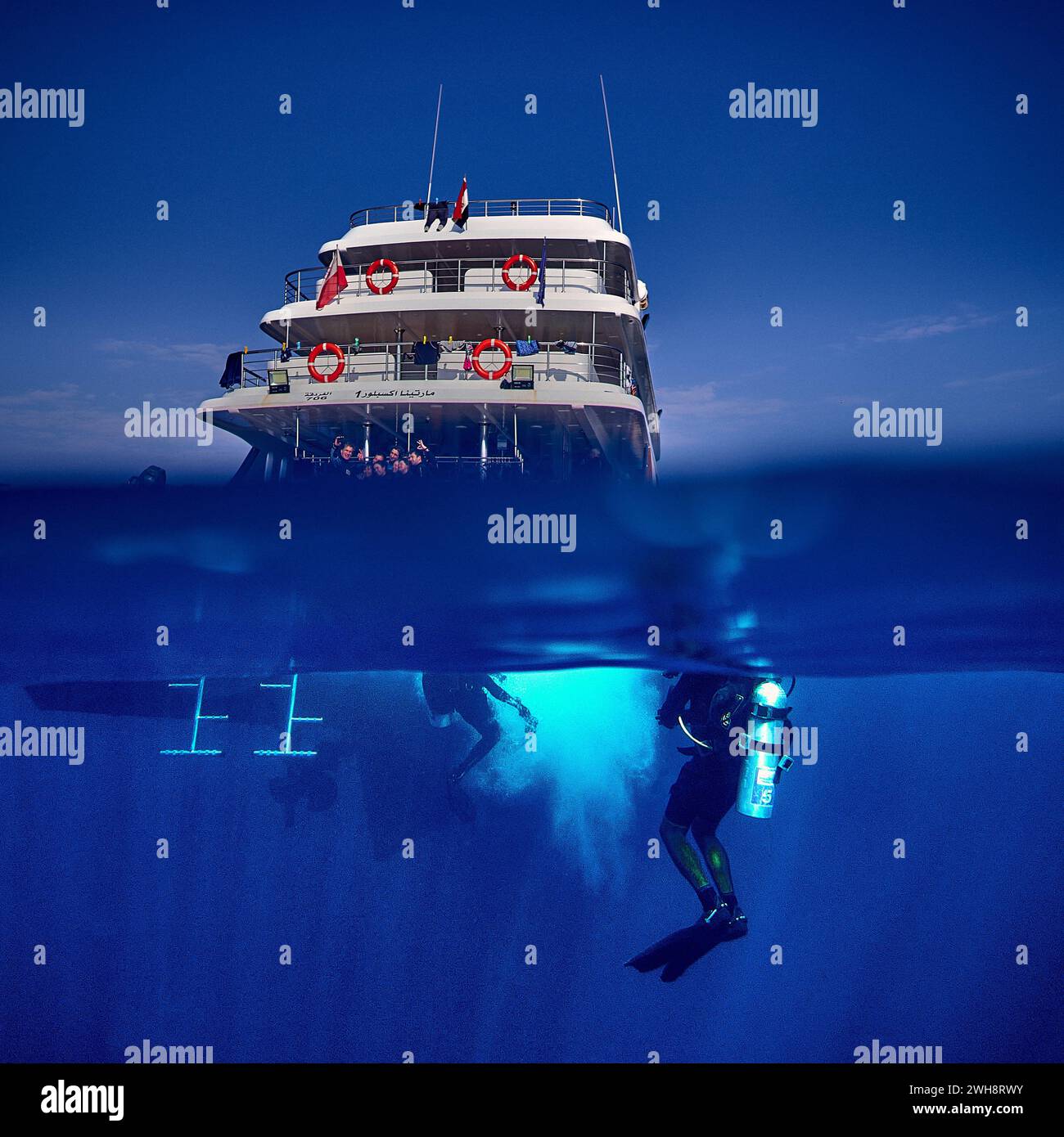 The beauty of the underwater world - diver jumping from boat into water ...