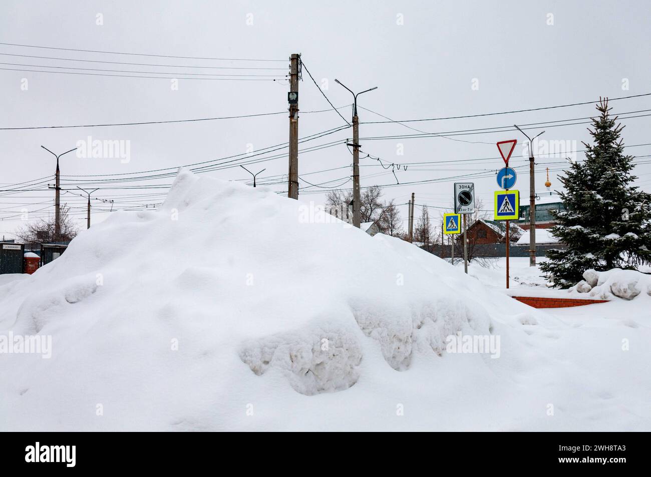Consequences of snowfall A huge mountain of snow on the roadway Samara ...